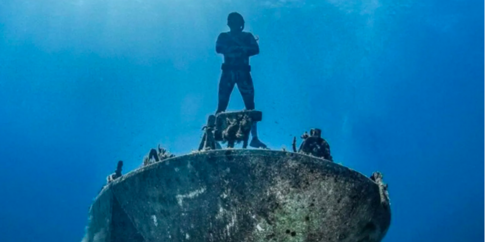Sheikh Hamdan stands on top of a sunken vessel; | OMNESmedia.com